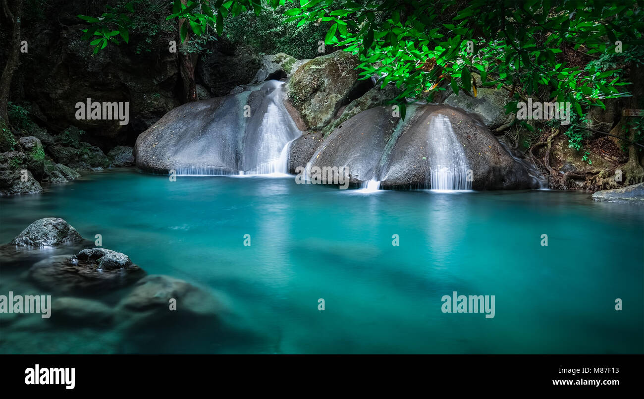 Jangle landscape with flowing turquoise water of Erawan cascade ...