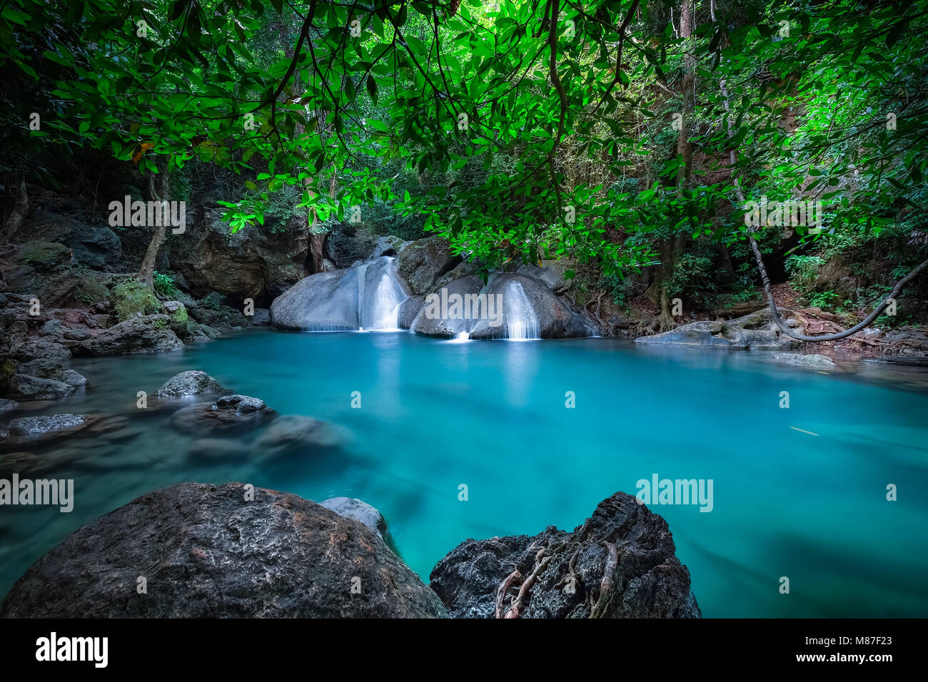 Jangle landscape with flowing turquoise water of Erawan cascade ...