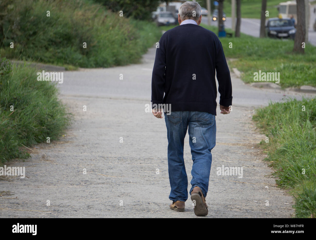 A man with his hands in jeans pockets Stock Photo - Alamy