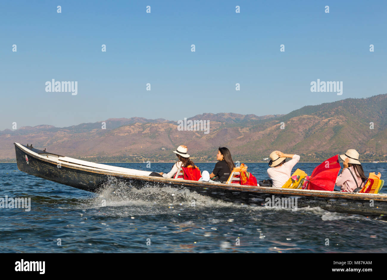 Tourists enjoying a ride in long tail boat at Inle Lake, Shan State ...
