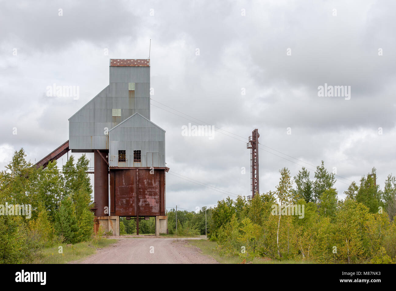 Abandoned copper mine with rock house ruins positioned in left frame ...