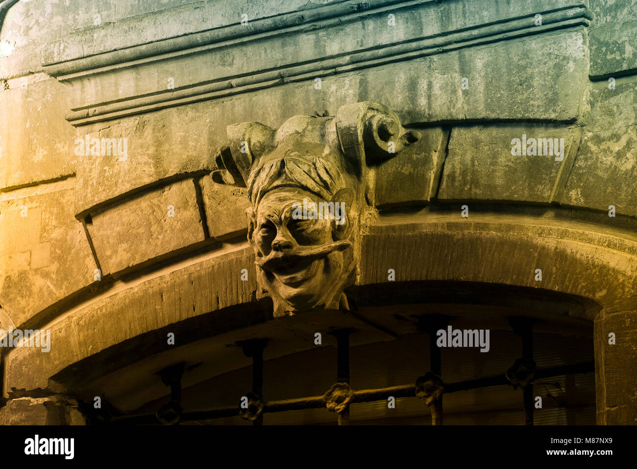 Head of the stone gatekeeper is located above the entrance of an ...