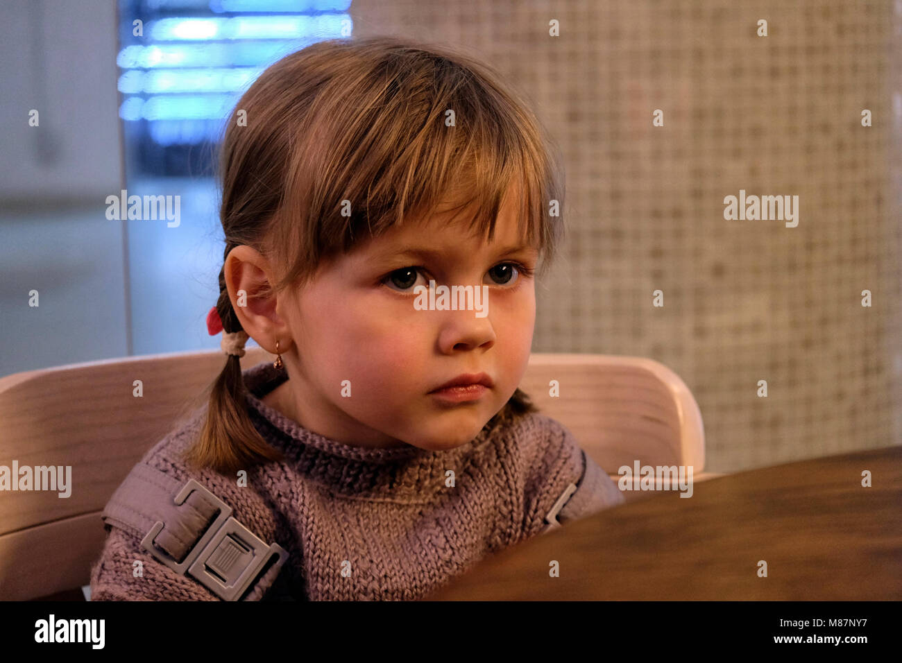 Little cute girl looks thoughtfully Stock Photo - Alamy