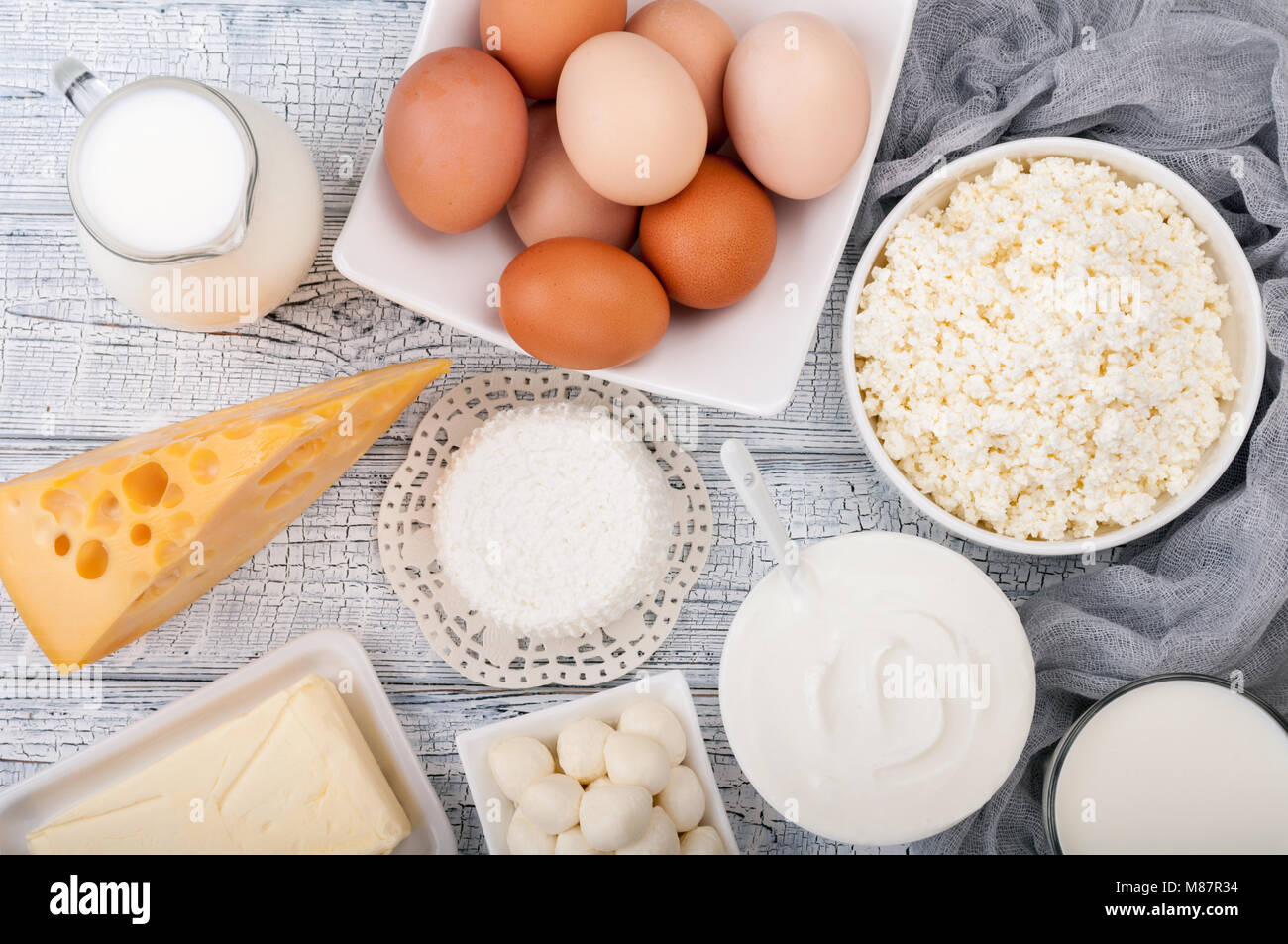Dairy products on wooden table. Milk, sour cream, cheese, egg, yogurt ...