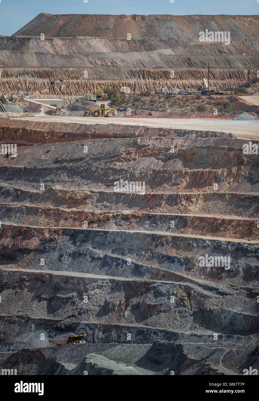 Panoramic view of open pit mine and blue sky located in the desert of ...
