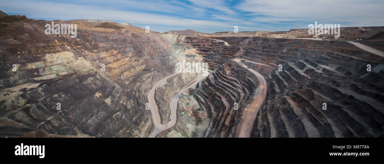 Panoramic view of open pit mine and blue sky located in the desert of ...