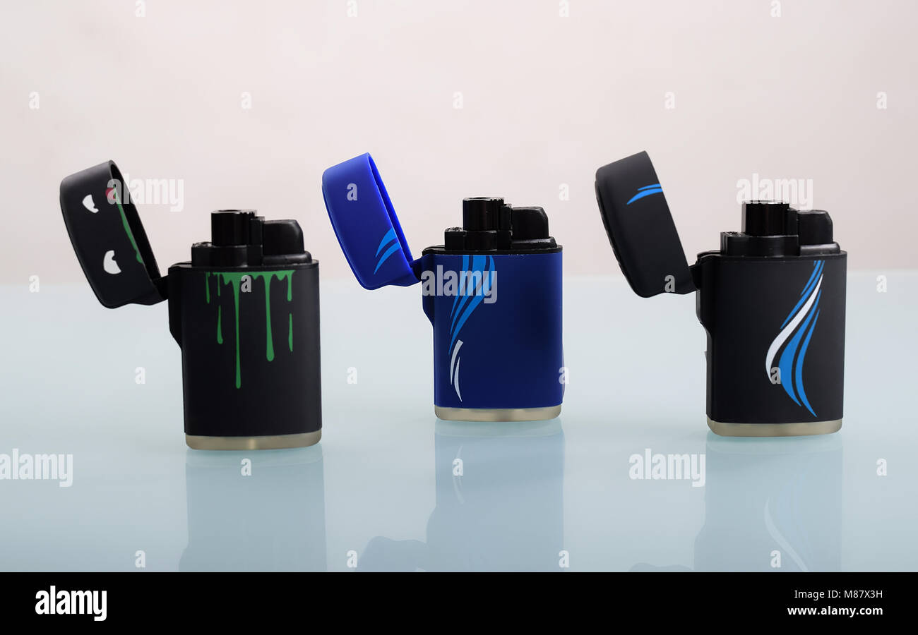 Three cigarette lighters Stock Photo - Alamy