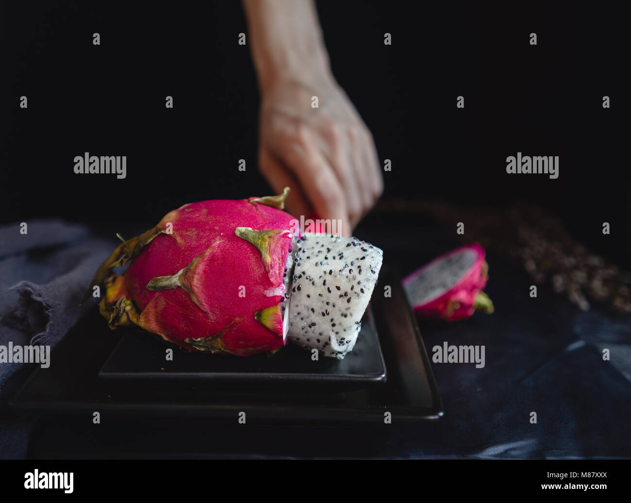 Bright Pink Pitaya Dragonfruit on a dark background. High Contrast ...