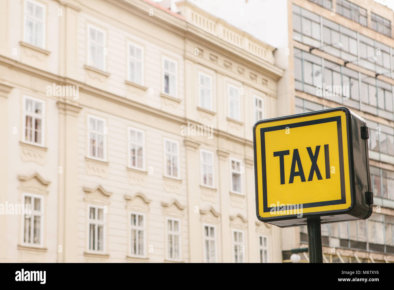 A modern taxi information sign on the background of houses in a ...