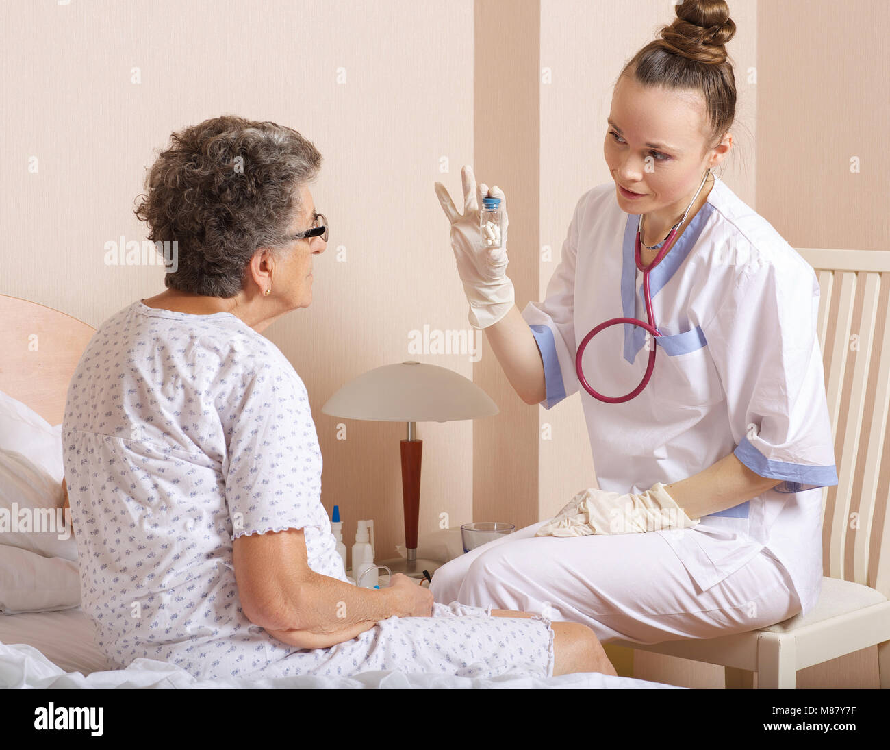 Geriatrician visits a senior woman between 70 and 80 years old in her ...