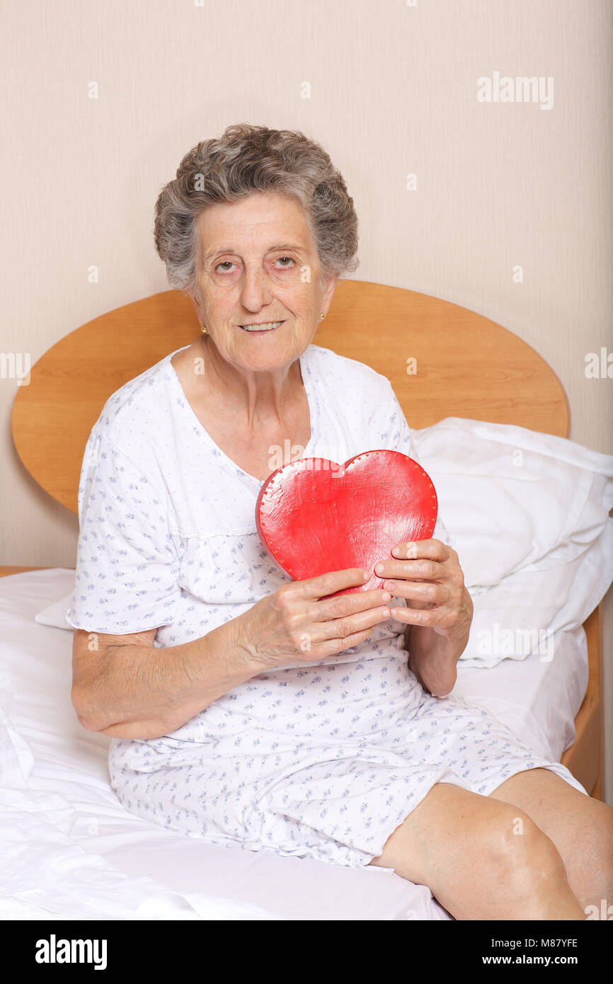 Old Woman Between 70 And 80 Years Old With Red Heart In Her Hands Stock