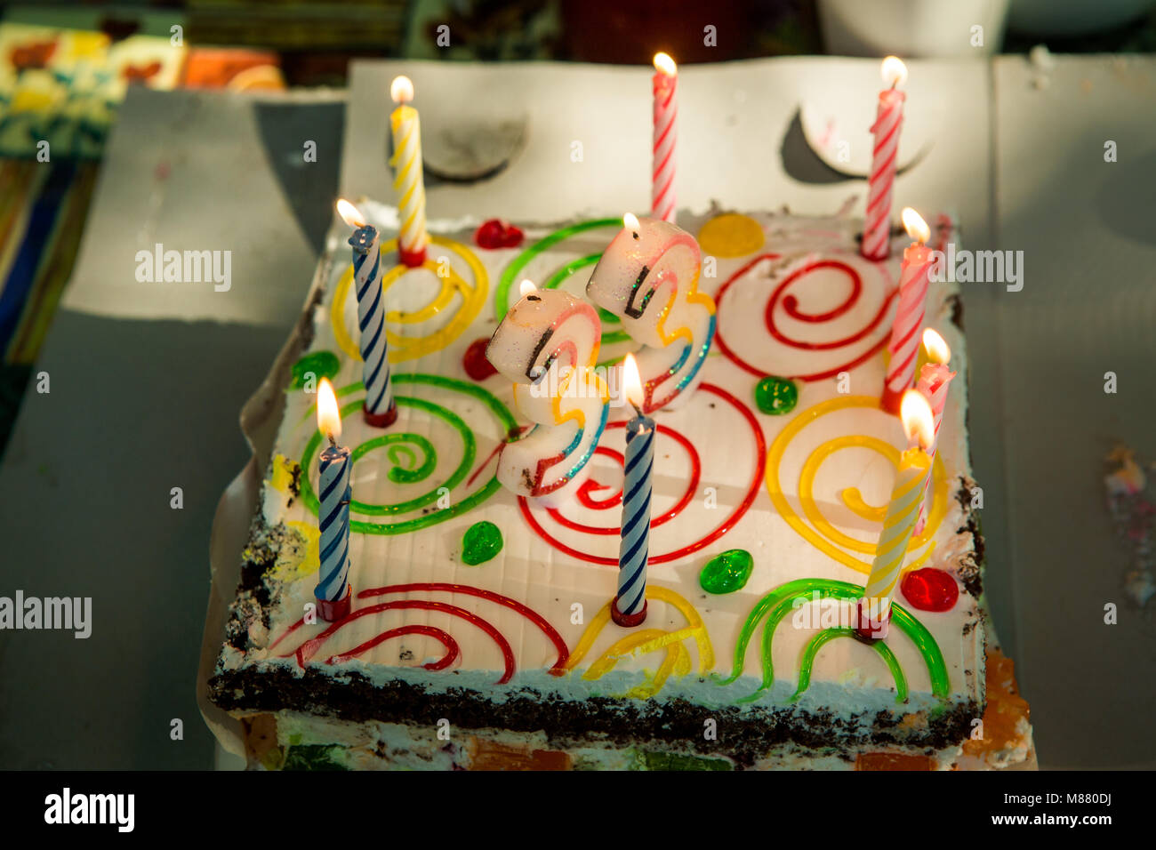 birthday colorful creamy and jelly cake with inflamed candles Stock ...