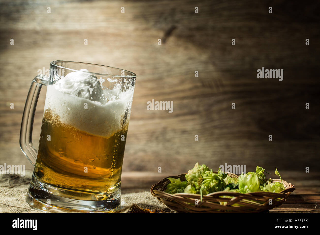 Big tankard of beer standing on empty wooden background Stock Photo - Alamy
