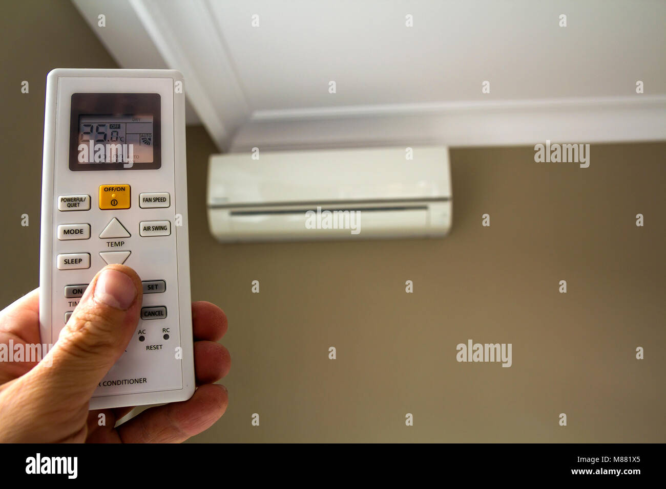 Hand holdind control switch of home air conditioner Stock Photo - Alamy