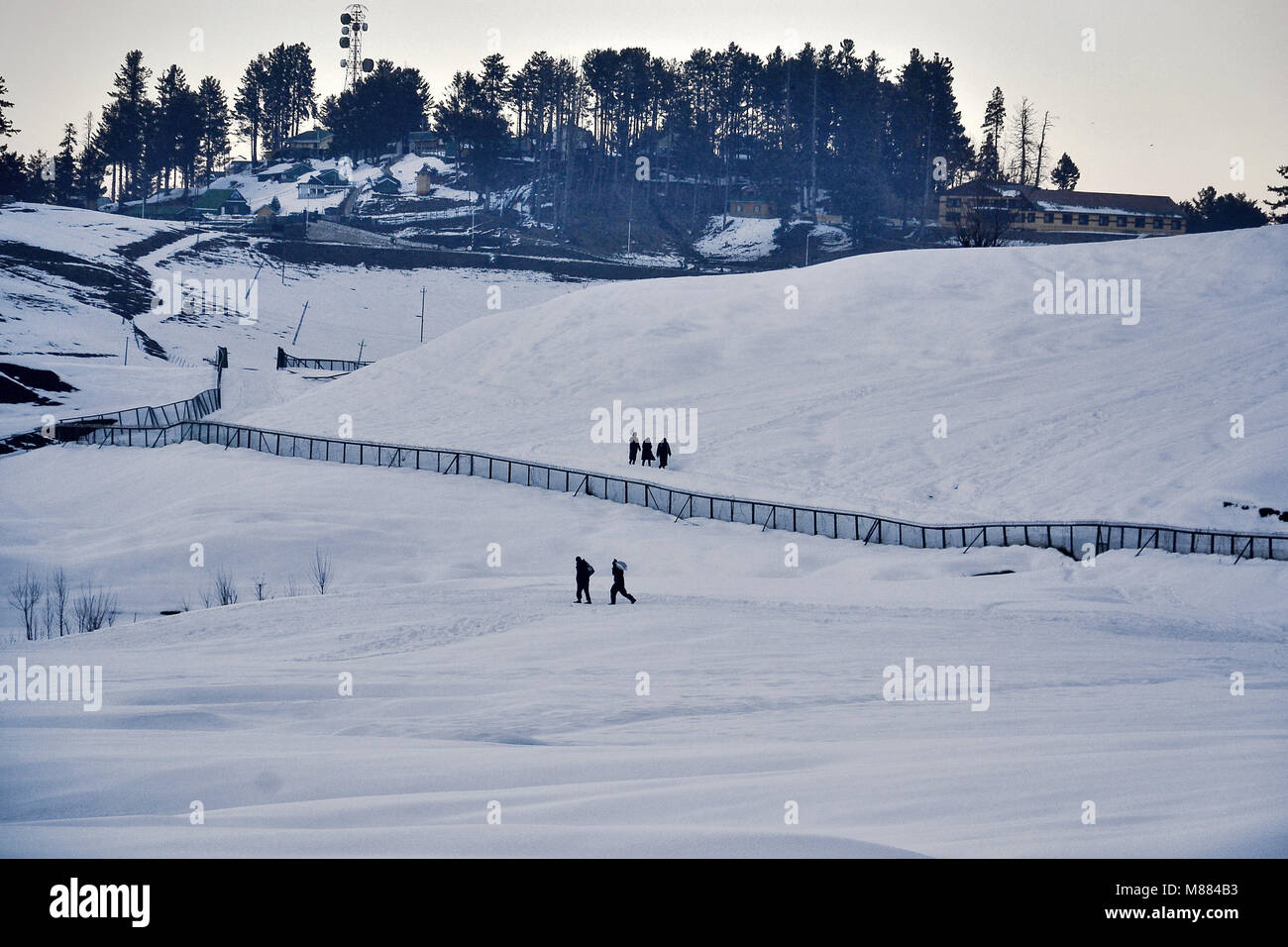 March 15, 2018 - Gulmarg, J&K, India - Tourists walk through snow in ...