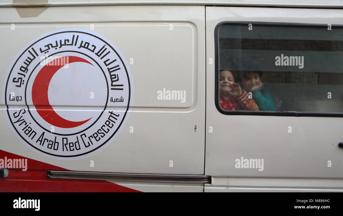 Syrian children reacts inside a Syrian Arab Red Crescent ambulance ...