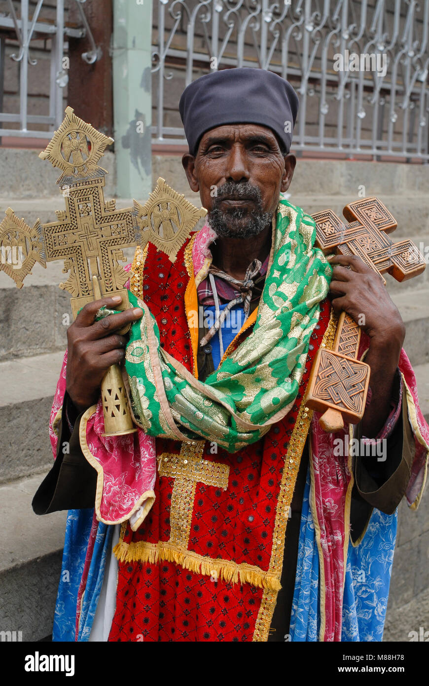 ETHIOPIA, Addis Ababa, orthodox priest with metal and wooden cross ...