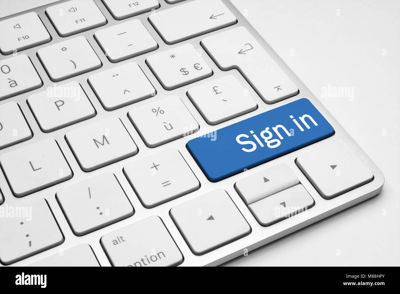 Blue Sign in button on a white keyboard isolated on a white background ...