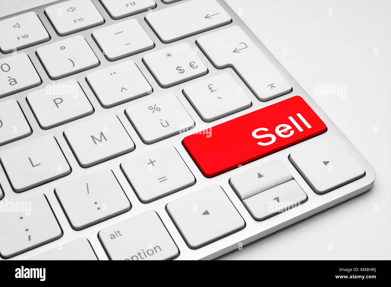 Red Sell button on a white keyboard isolated on a white background ...