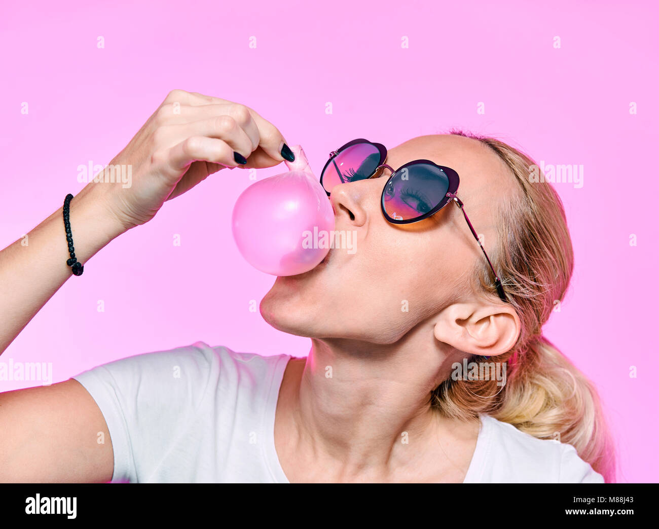 Girl blowing chewing gum bubble hi-res stock photography and images - Alamy