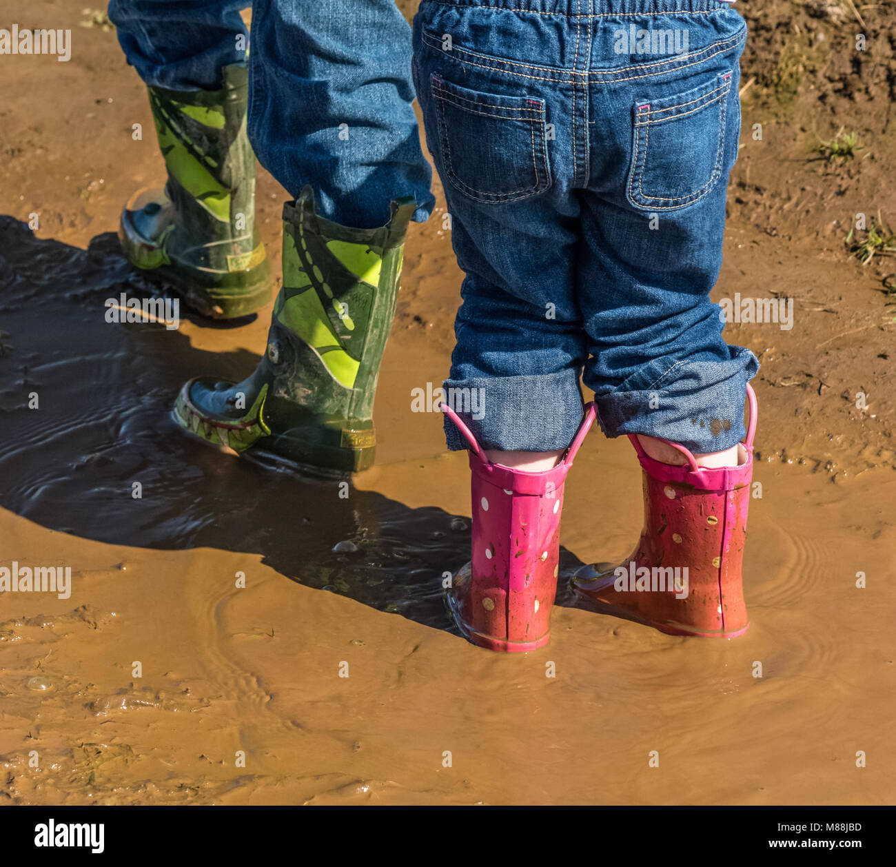 Child splash puddles boots hi-res stock photography and images - Alamy