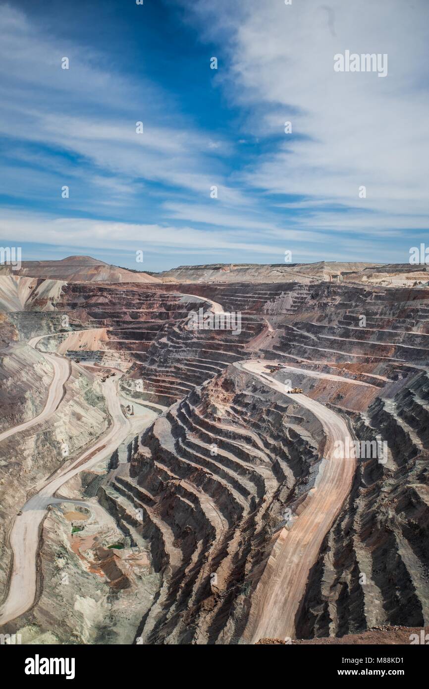 Panoramic view of open pit mine and blue sky located in the desert of ...
