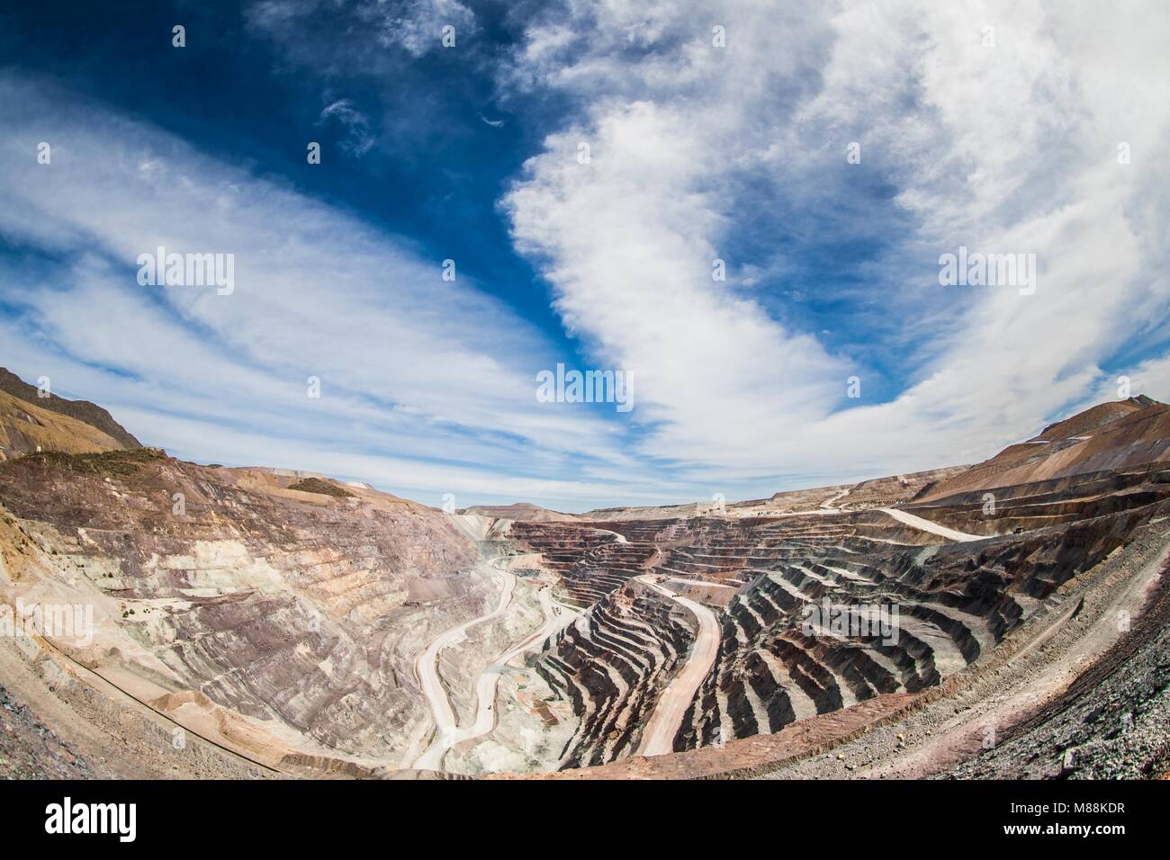 Panoramic view of open pit mine and blue sky located in the desert of ...