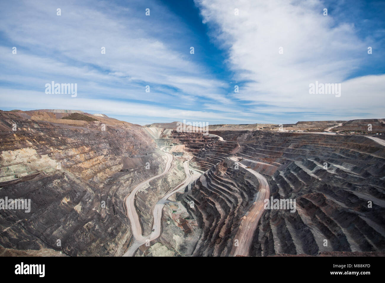 Panoramic view of open pit mine and blue sky located in the desert of ...