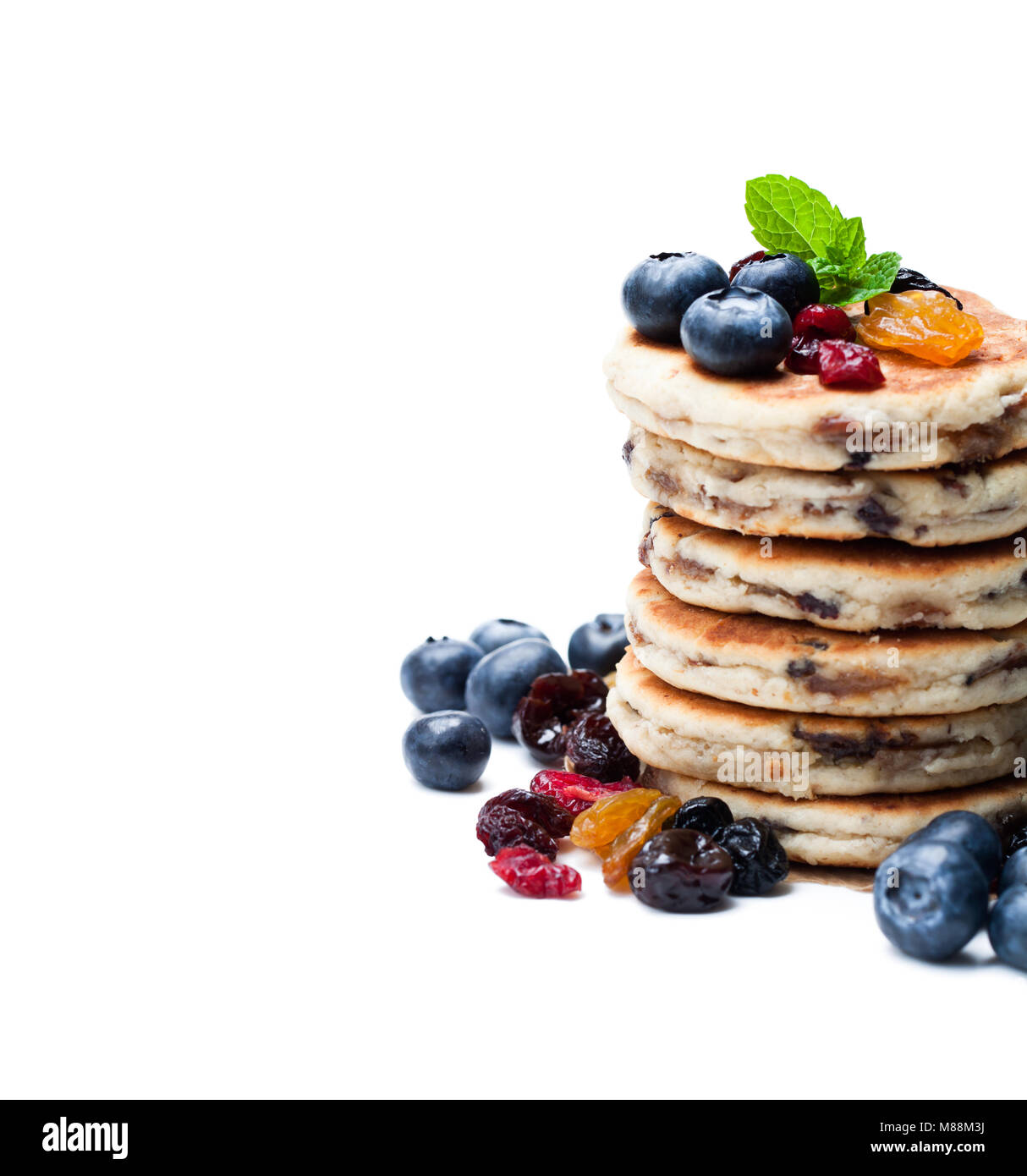 Stack of welsh cakes with dry berries and fresh blueberries isolated on ...