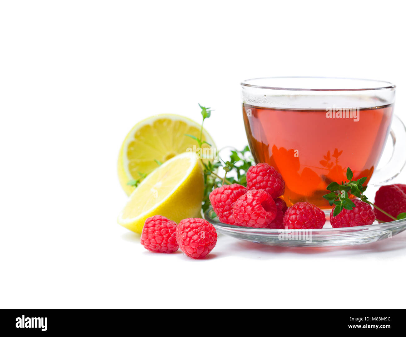 Red fruit tea with lemon and raspberry isolated on white background ...