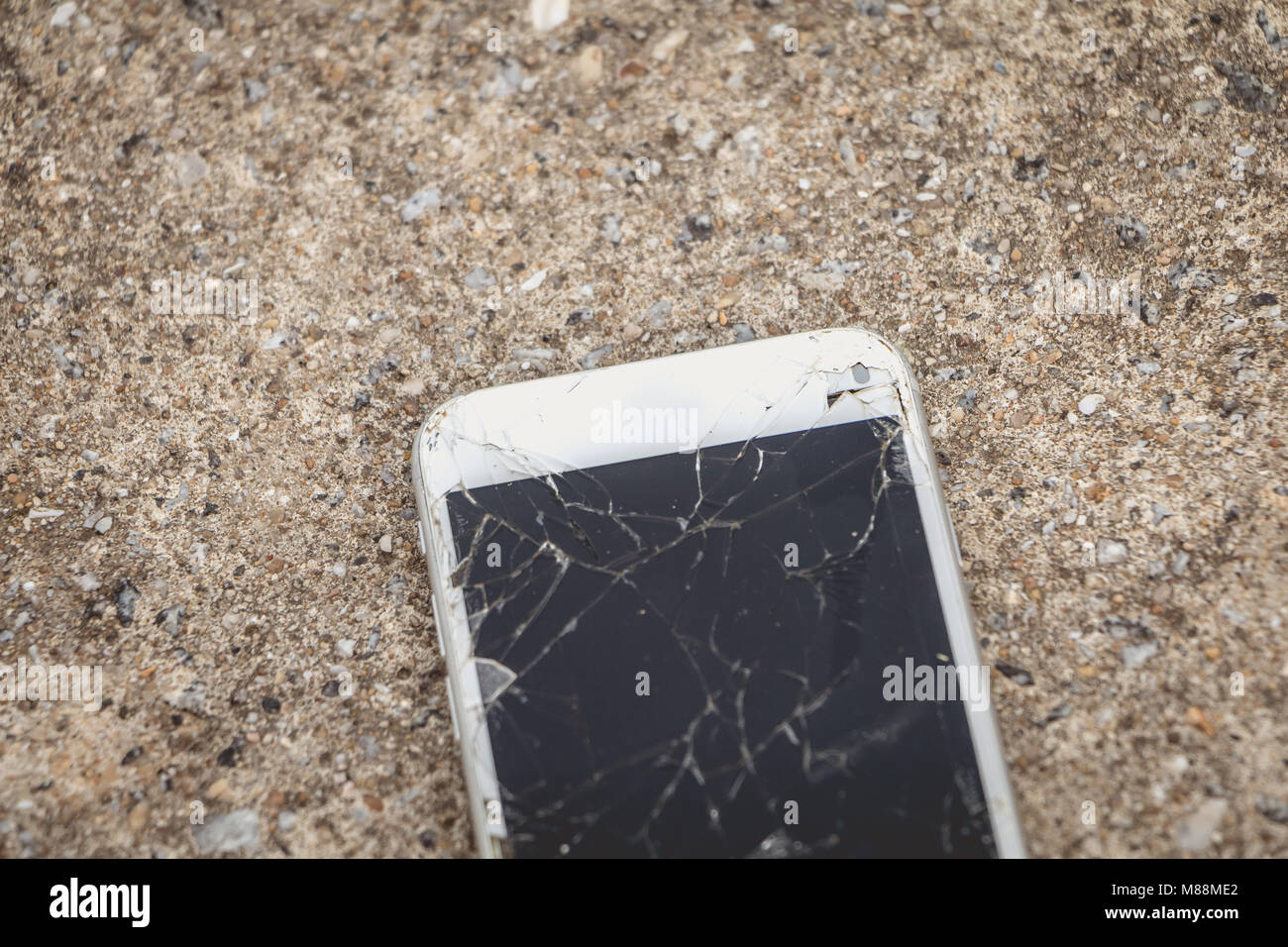 Broken smartphone fallen on a reinforced concrete floor Stock Photo - Alamy