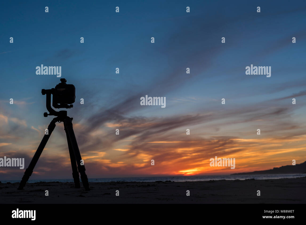 camera on tripod photographing the sunset Stock Photo - Alamy