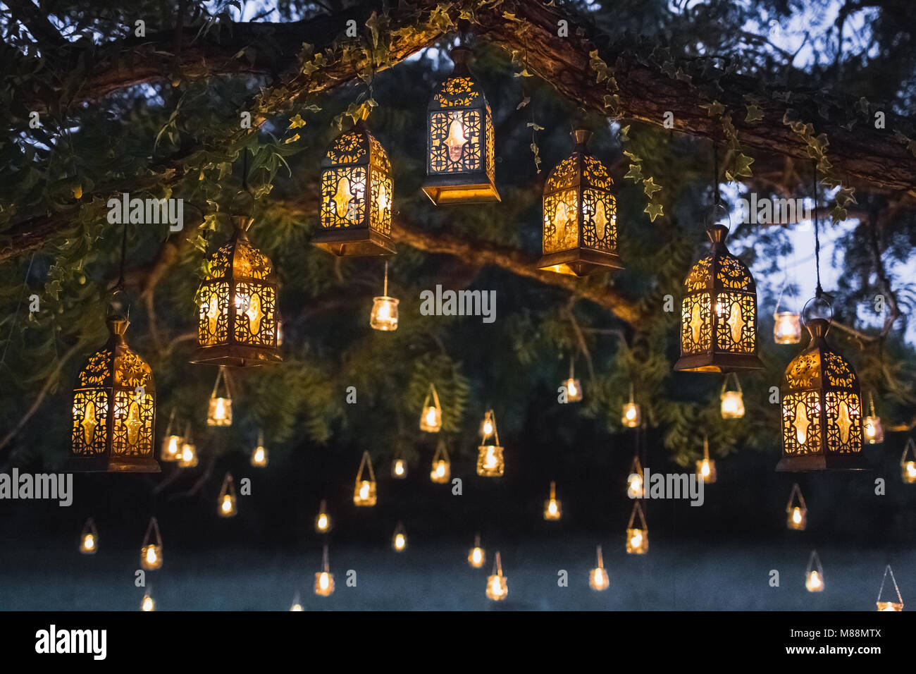 Night wedding ceremony with a lot of vintage lamps and candles on big ...