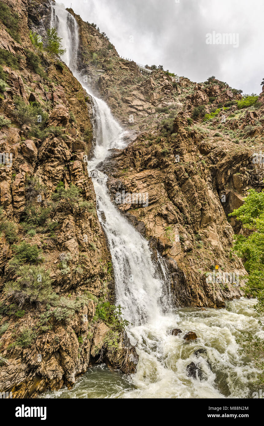 High, steep, waterfall rushing to a river below Stock Photo - Alamy