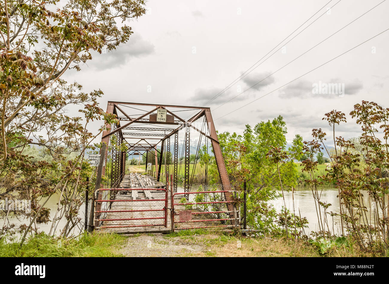 Rusty bridge with wood deck that is in very bad shape has been gated ...