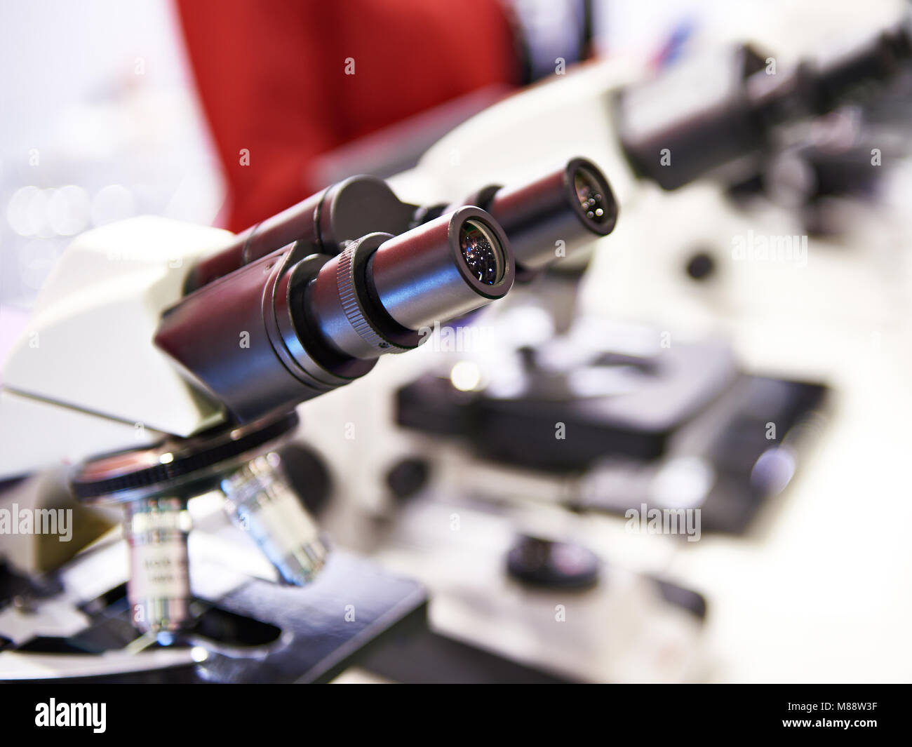 Microscope eyepieces on blur background Stock Photo - Alamy