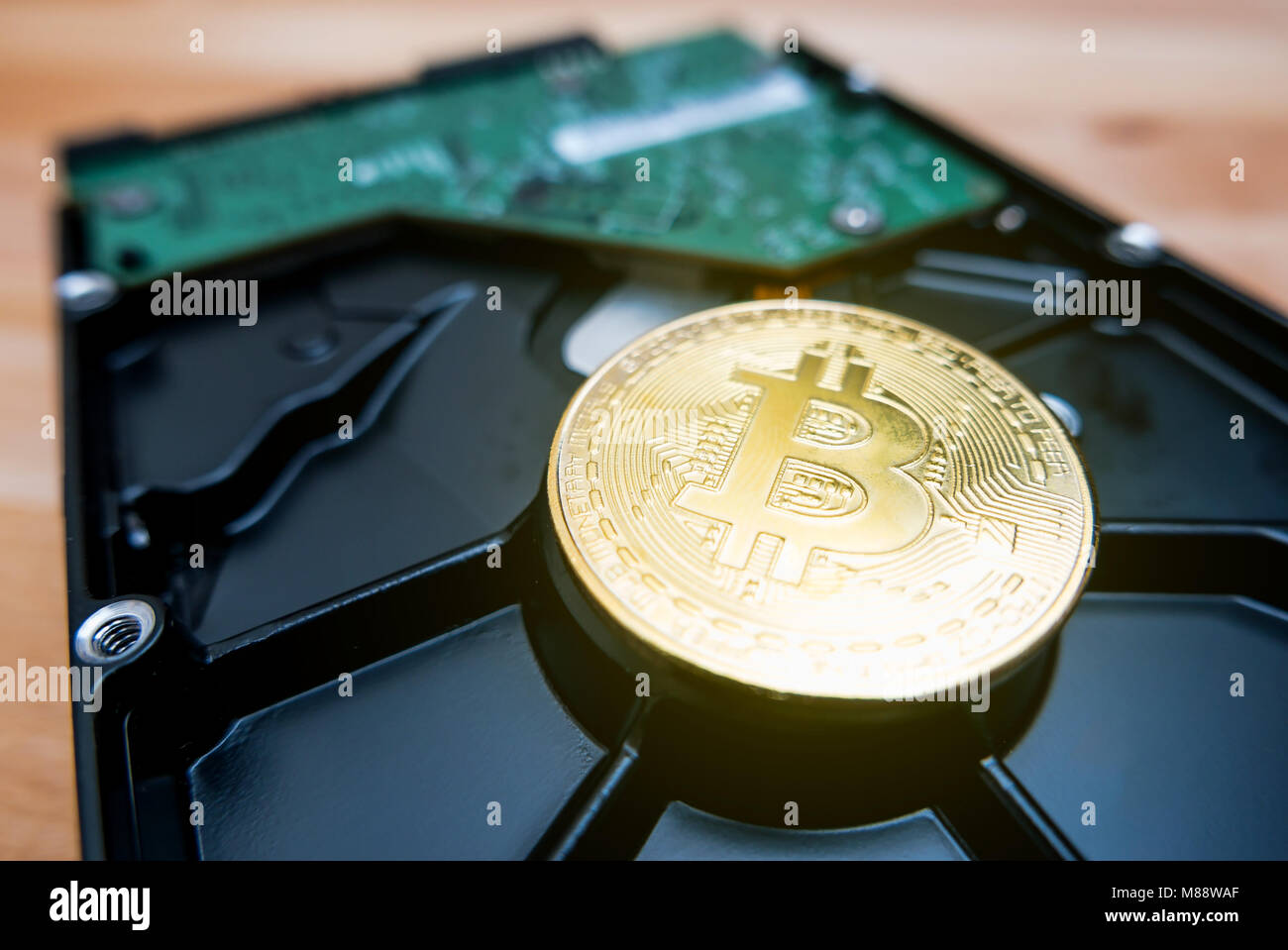 Cryptocurrency Golden Bitcoin on hard disk drive with blur background ...