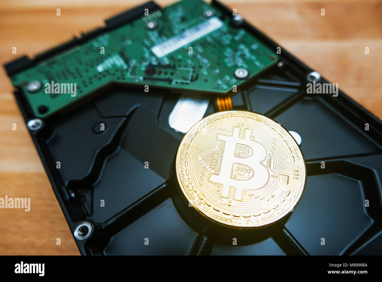 Cryptocurrency Golden Bitcoin on hard disk drive with blur background ...