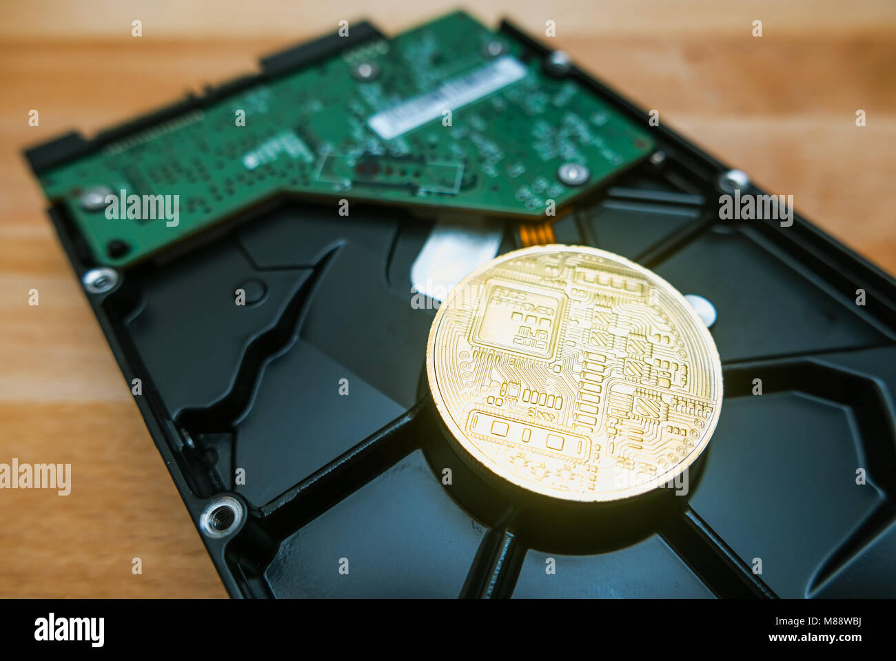 Cryptocurrency Golden Bitcoin on hard disk drive with blur background ...