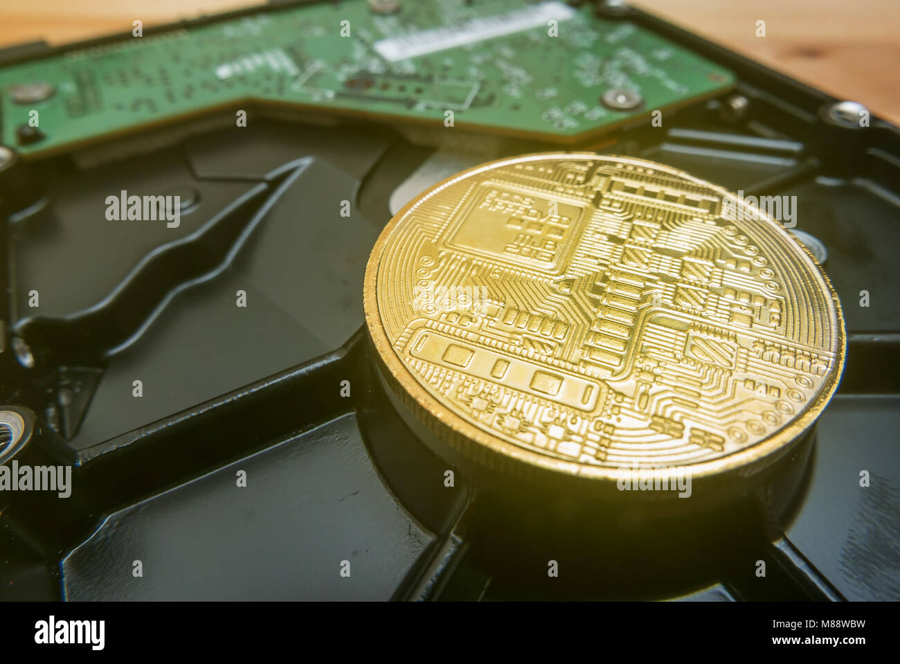 Cryptocurrency Golden Bitcoin on hard disk drive with blur background ...