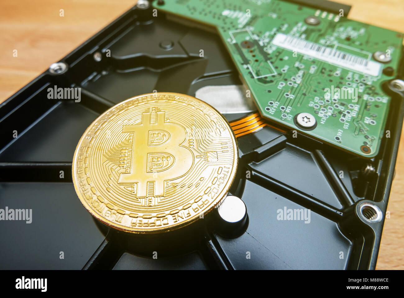 Cryptocurrency Golden Bitcoin on hard disk drive with blur background ...