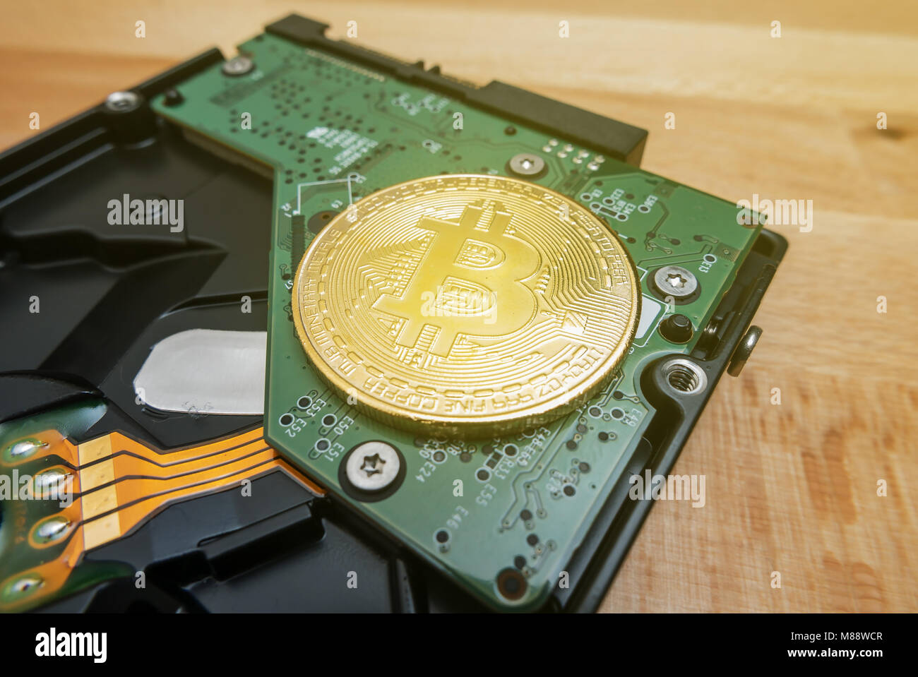 Cryptocurrency Golden Bitcoin on hard disk drive with blur background ...