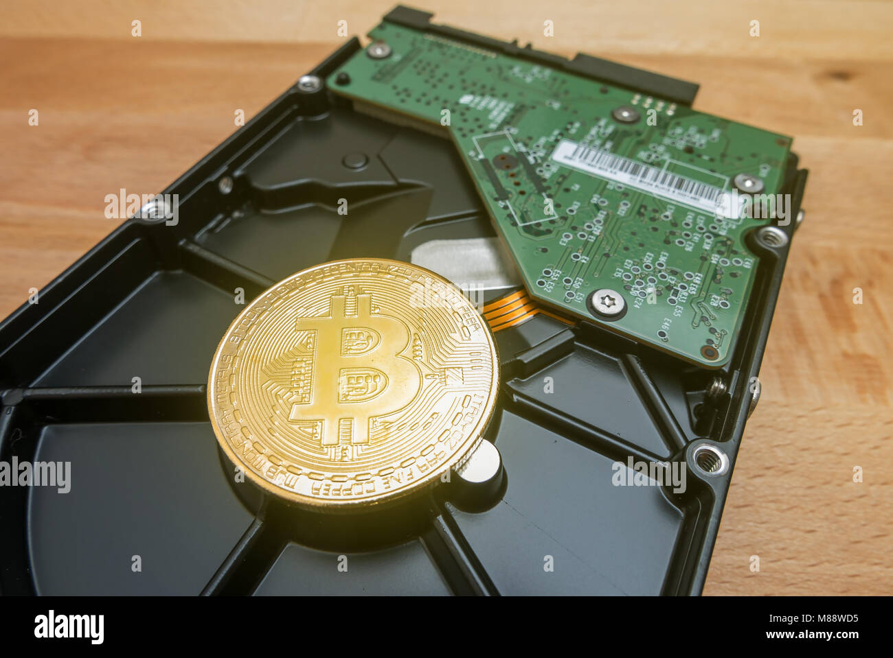 Cryptocurrency Golden Bitcoin on hard disk drive with blur background ...