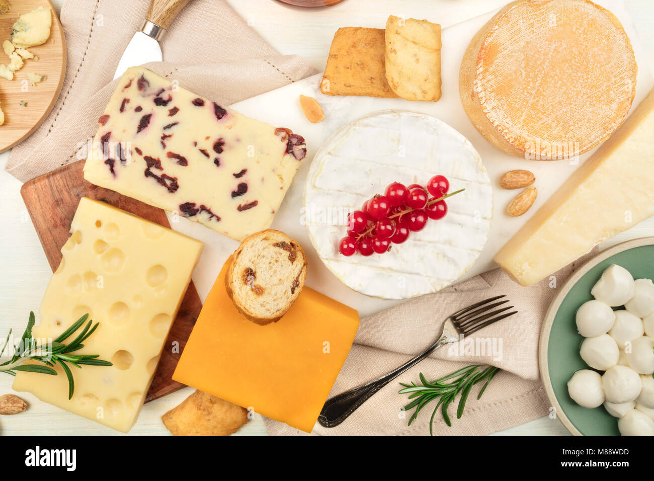 An assortment of various types of cheese, shot from above on a light ...