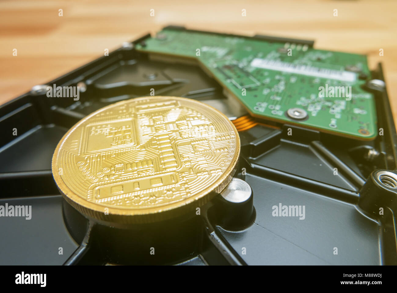 Cryptocurrency Golden Bitcoin on hard disk drive with blur background ...