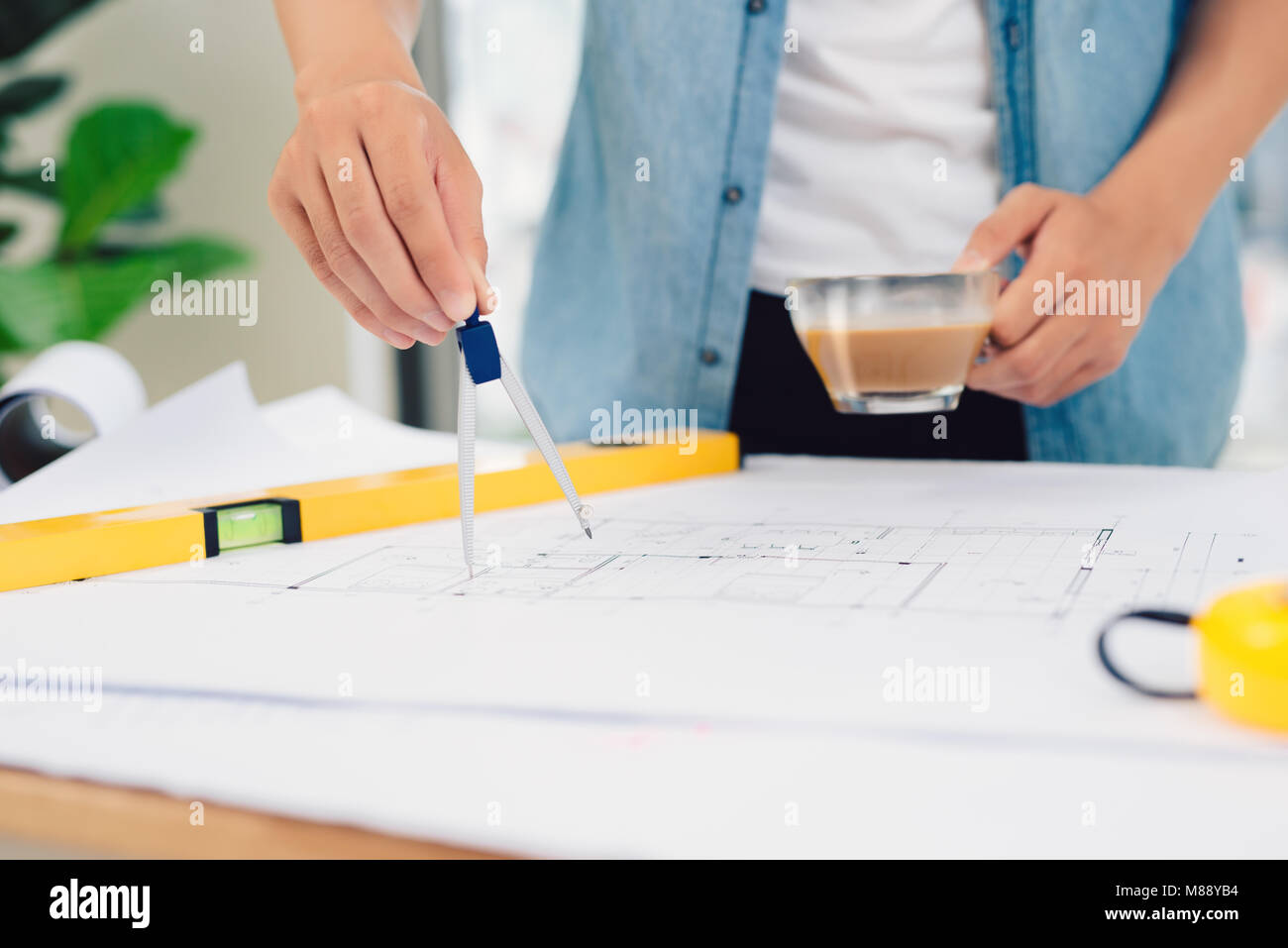 architect working and sketching architectural drawing plan on table in ...