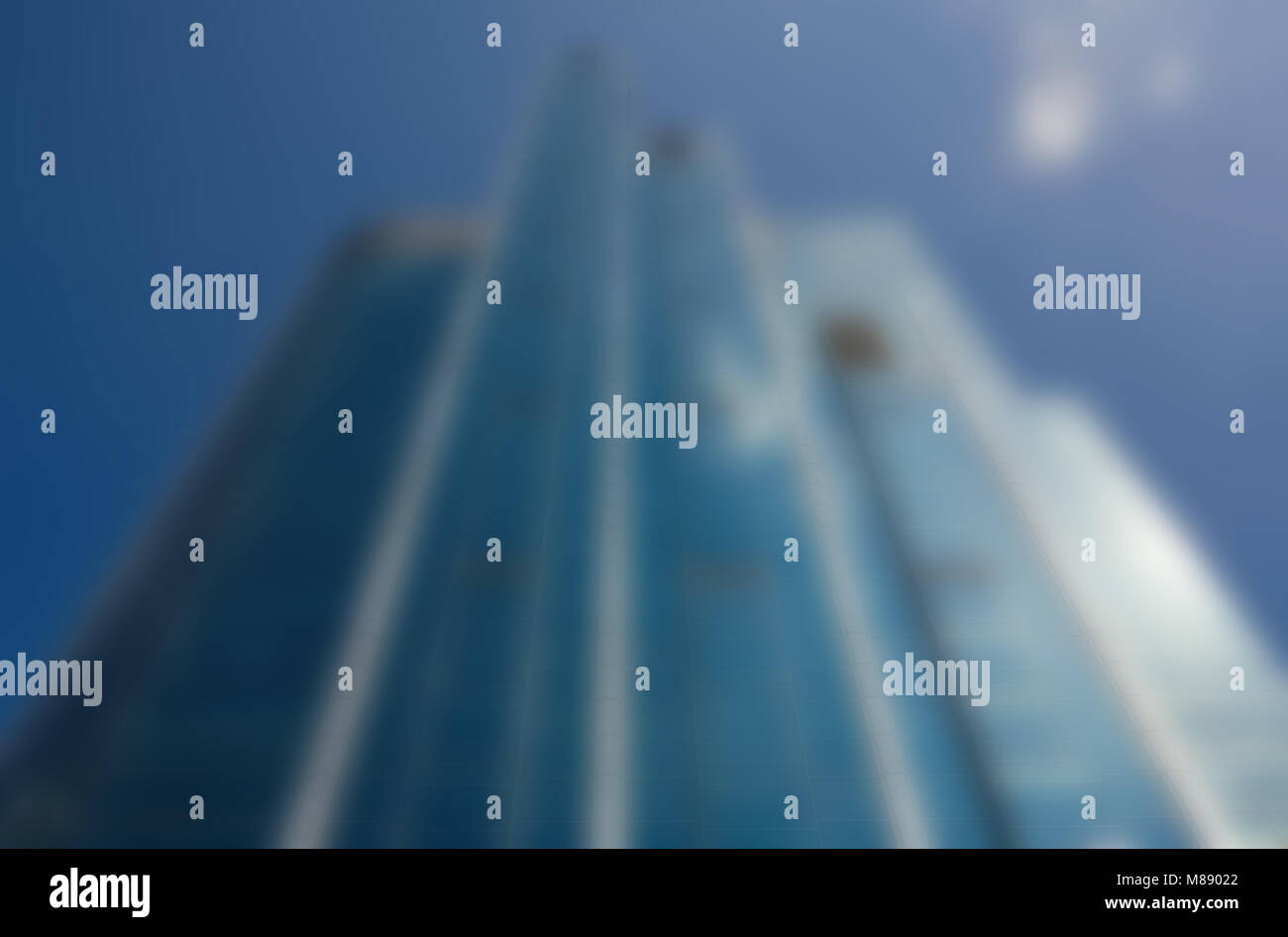 Blurred low angle image of the glass facade of a modern skyscraper ...