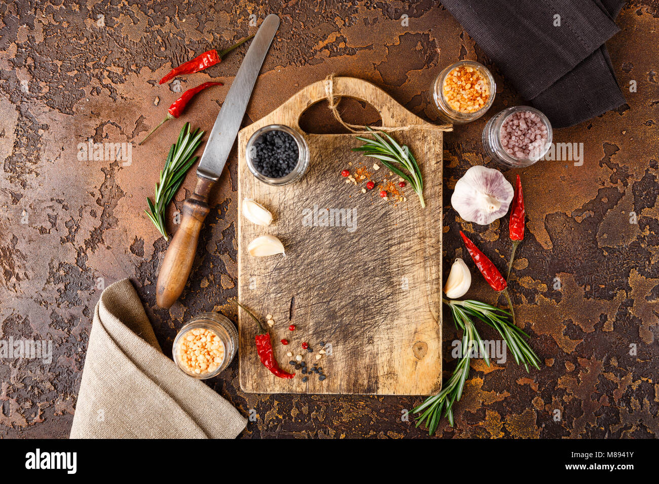 Cooking table with herbs, spices and utensils. Top view with copy space ...