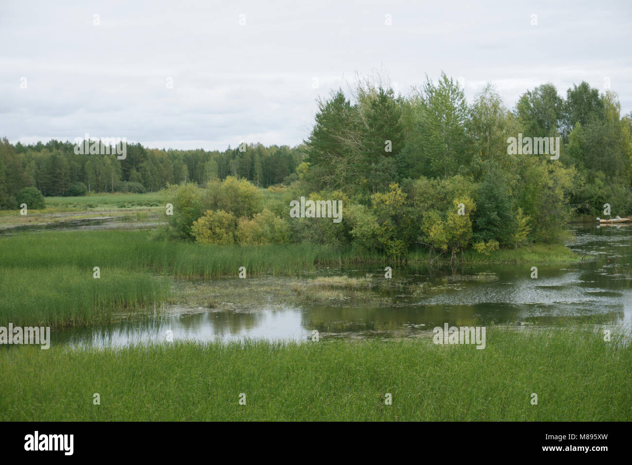 summer, in July the sun slowly sets in the typical landscape. This ...