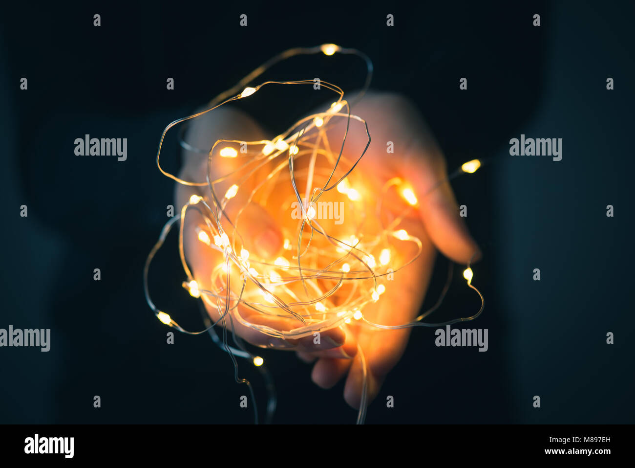 Hands holding christmas lights, concept image for energy or magic Stock ...